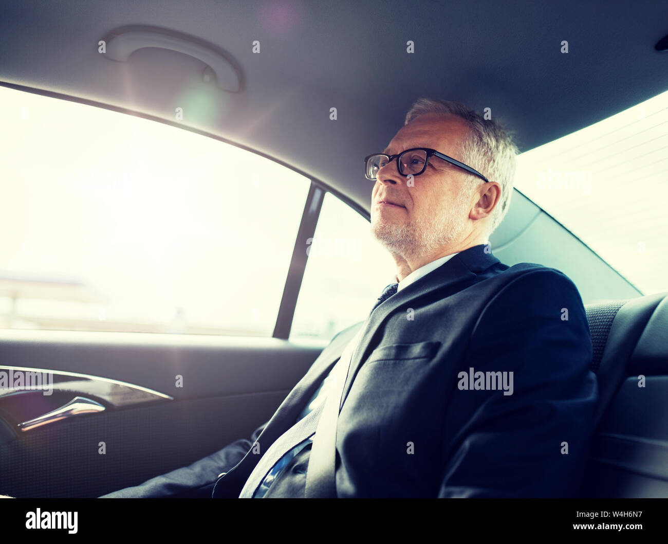 senior businessman driving on car back seat Stock Photo - Alamy