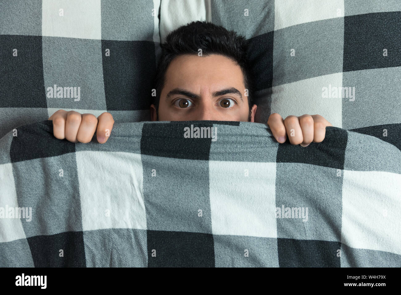 Man hiding under duvet hi-res stock photography and images - Alamy