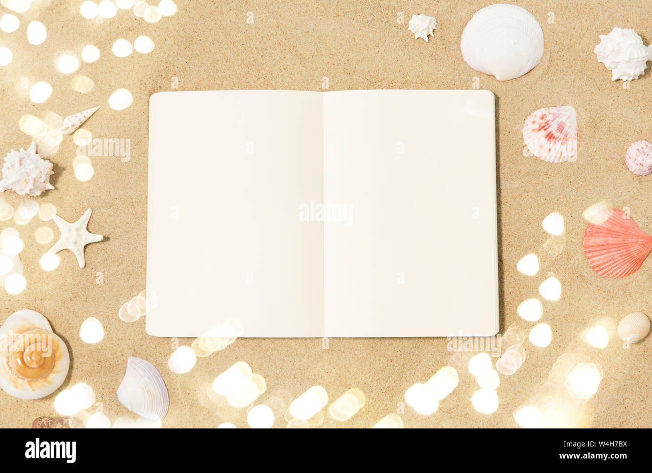 notebook with seashells on beach sand Stock Photo - Alamy