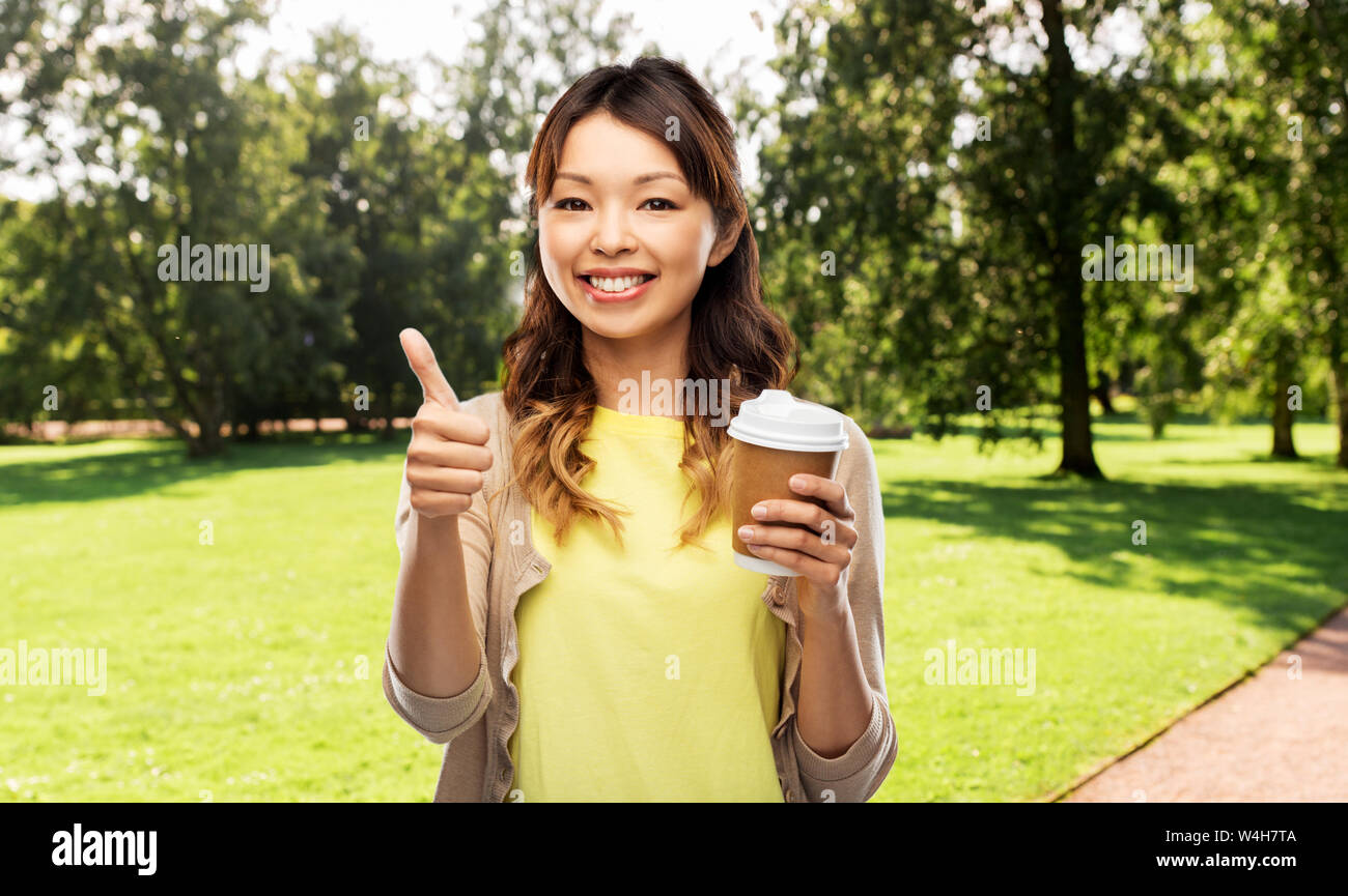 asian woman drinking coffee and showing thumbs up Stock Photo - Alamy