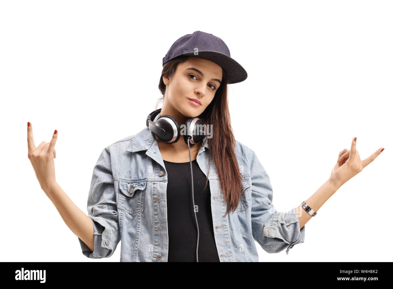 Young female with headphones making rock hand sign isolated on white ...