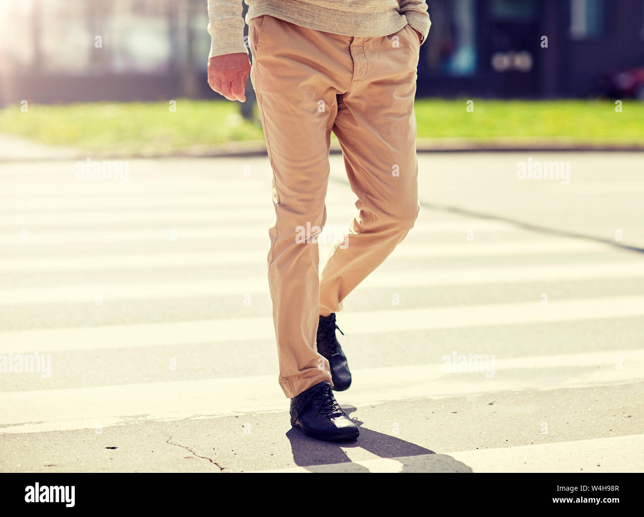 senior man walking along city crosswalk Stock Photo - Alamy