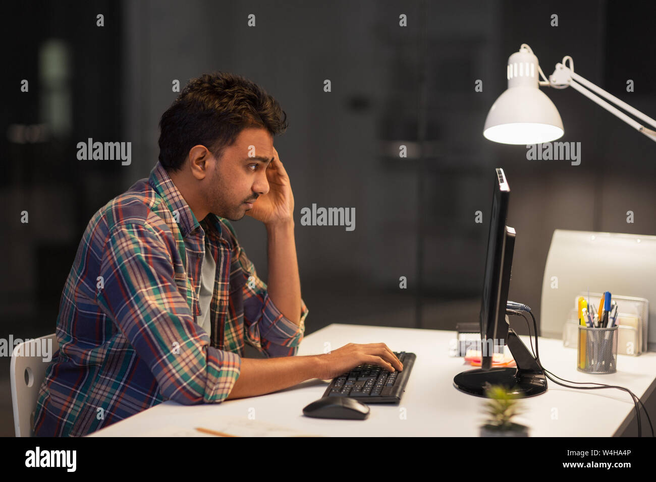 creative man with computer working at night office Stock Photo - Alamy