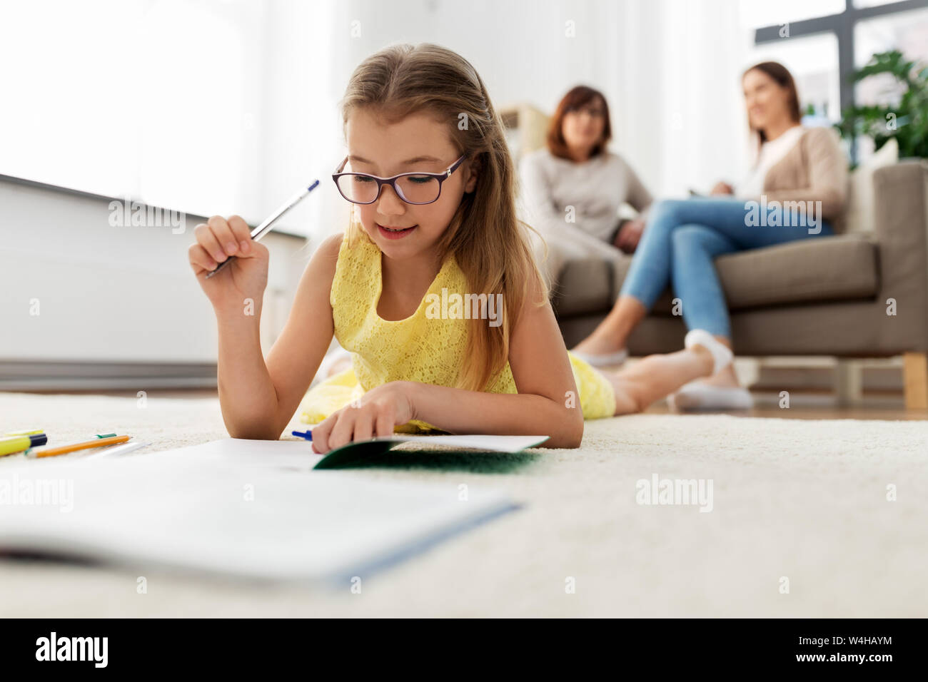 student girl writing to notebook at home Stock Photo - Alamy