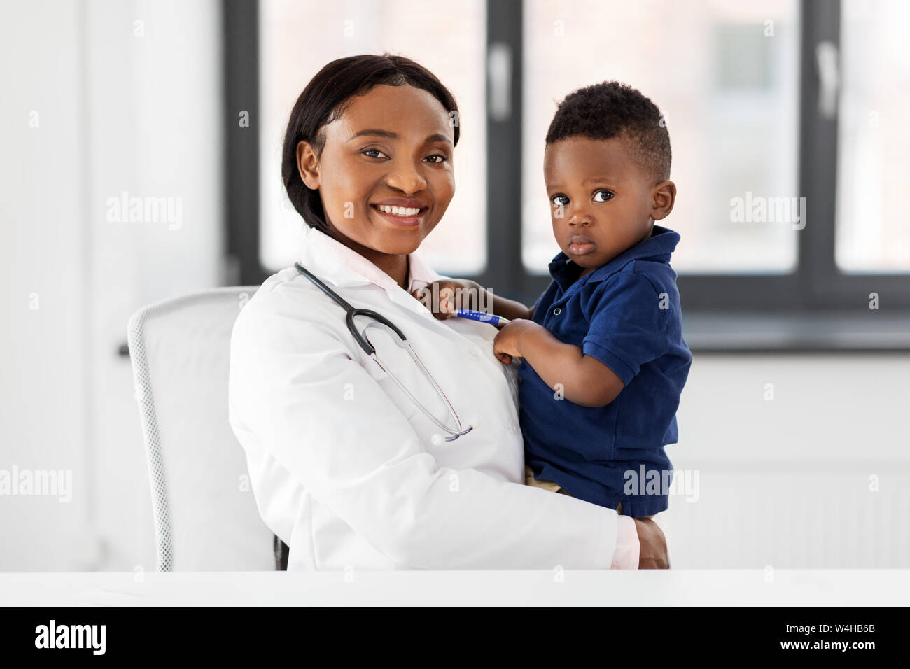 doctor or pediatrician with baby patient at clinic Stock Photo - Alamy