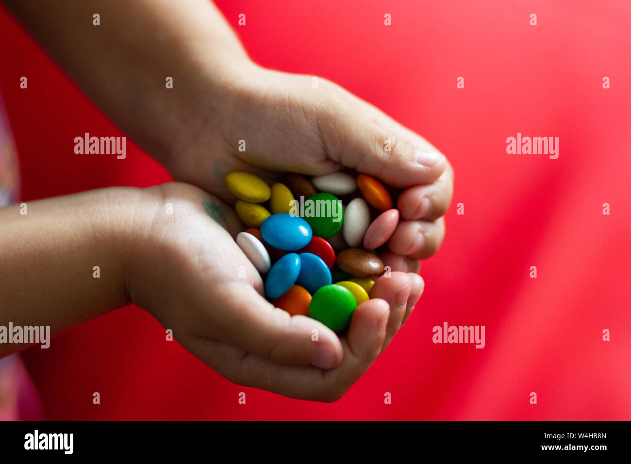 Sweet colorful round candies in child hands in shape of heart Stock ...