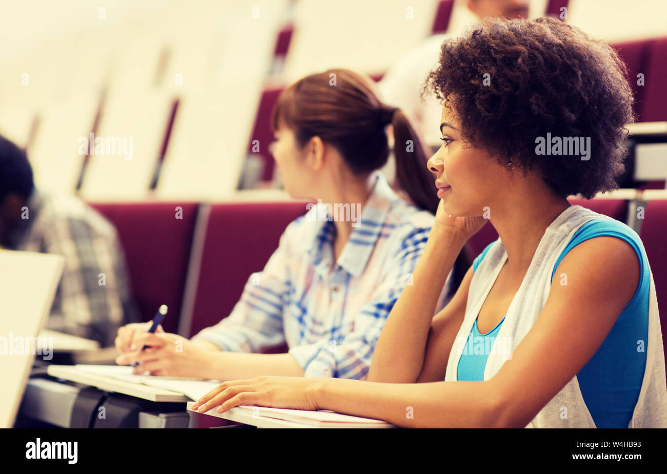 group of students talking in lecture hall Stock Photo - Alamy