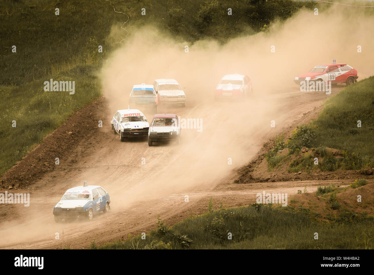 Traditional rally .The racing car drives into a steep turn, scattering ...