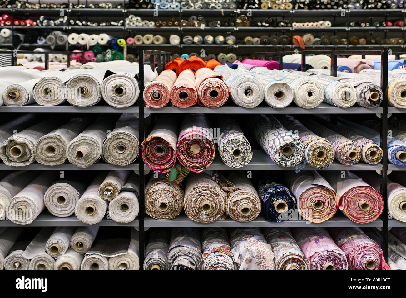 Fabric warehouse with many multicolored textile rolls Stock Photo Alamy