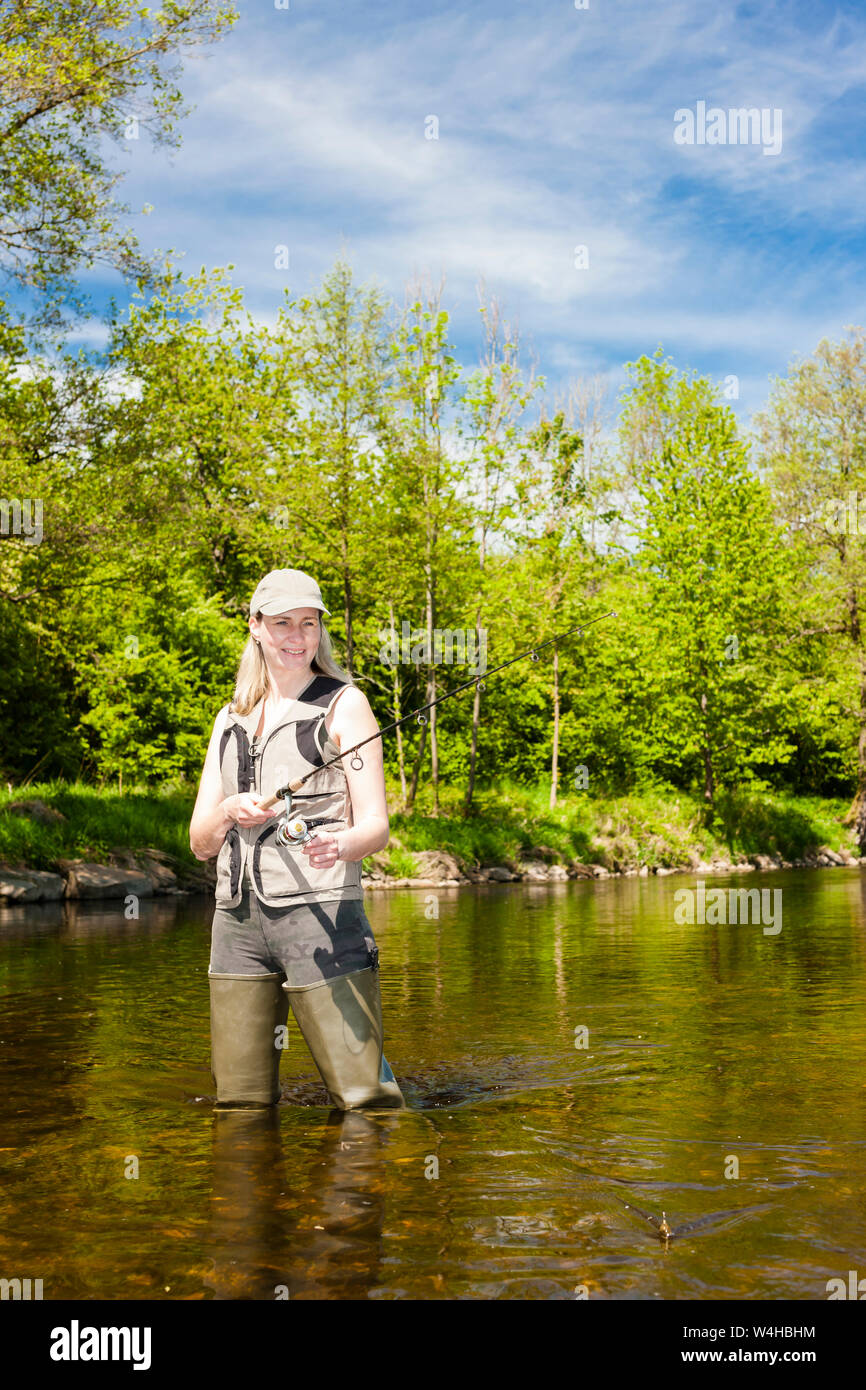 woman fishing in the river in spring Stock Photo - Alamy