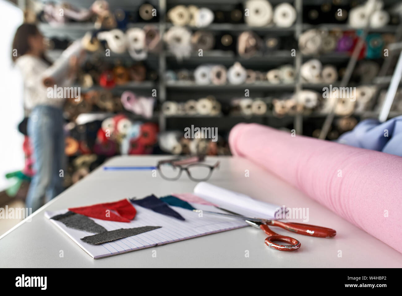 Fabric warehouse with many multicolored textile rolls Stock Photo - Alamy