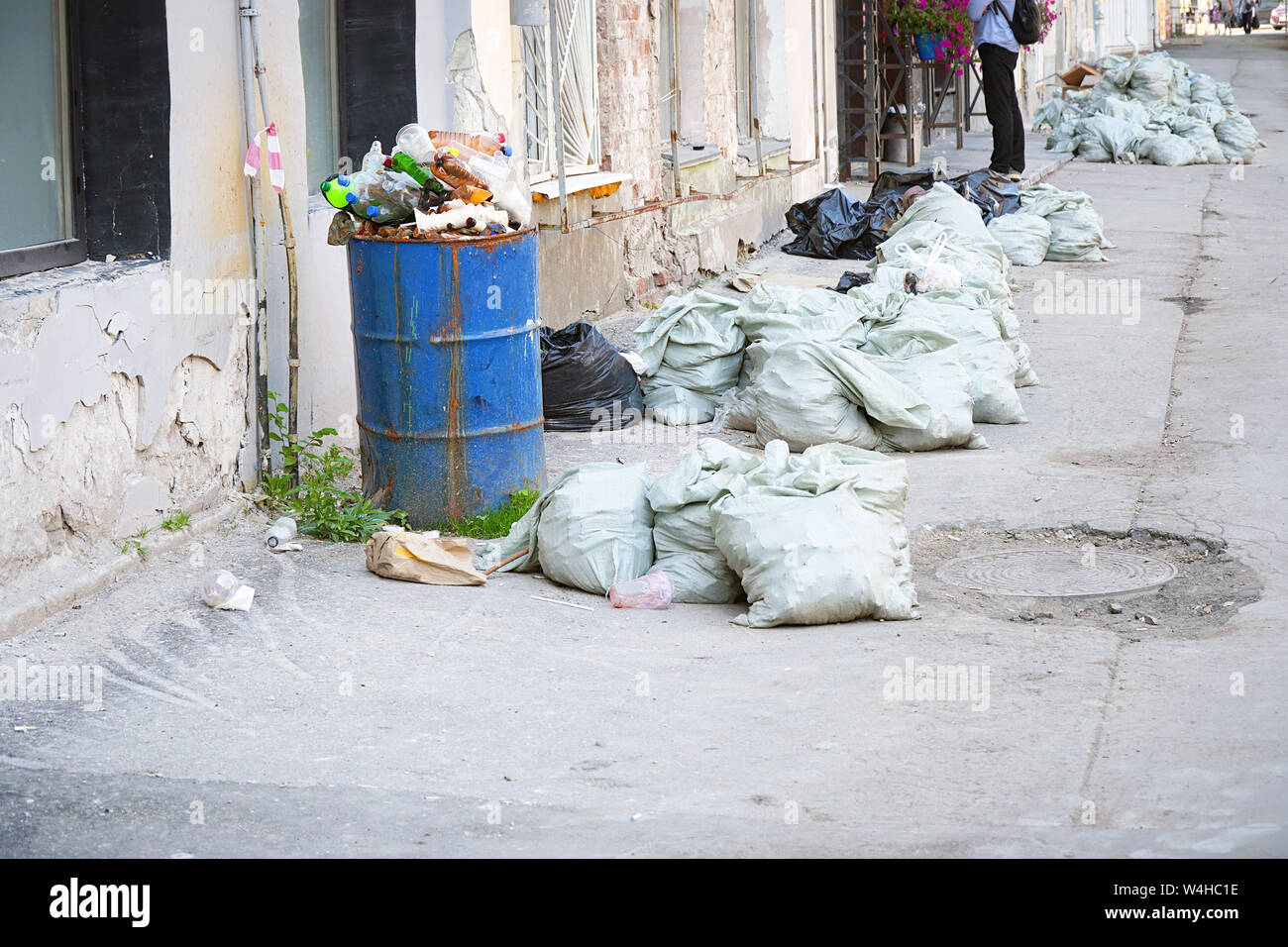 Garbage in bags and barrels on streets Stock Photo - Alamy