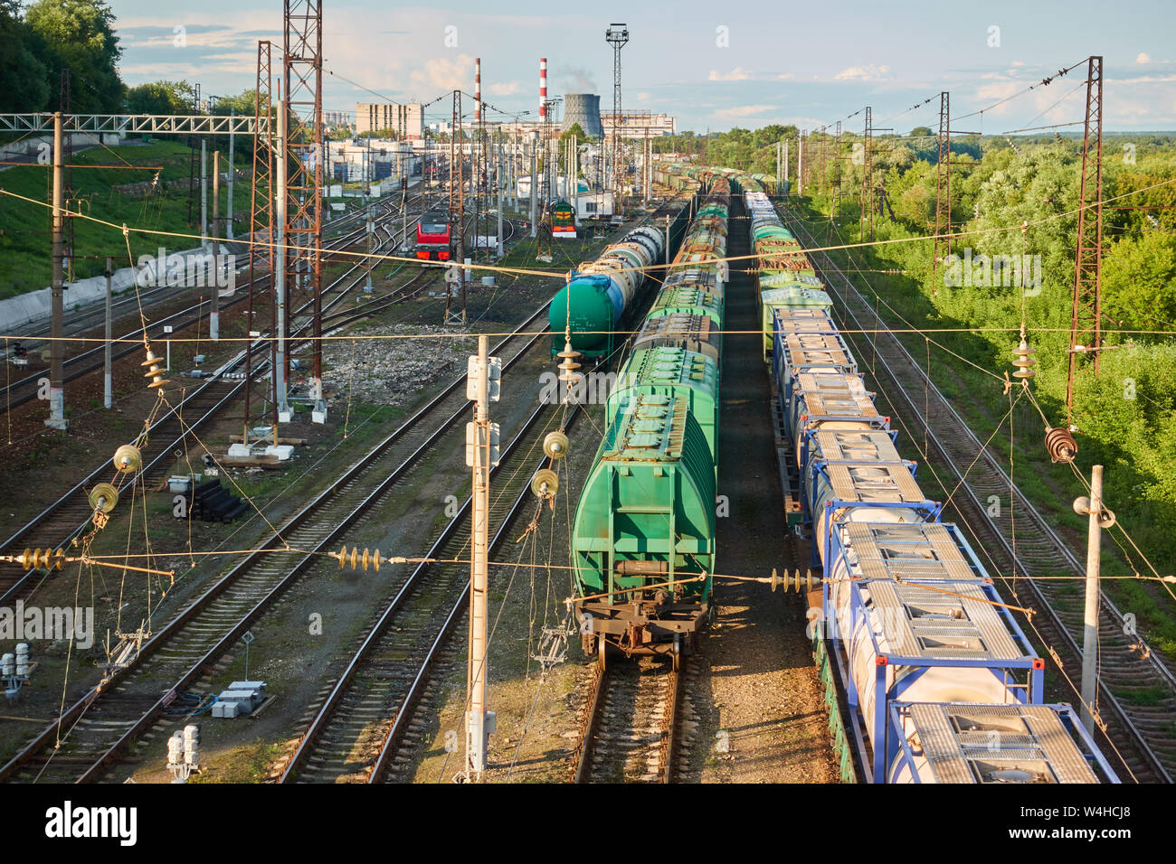 Trains on the railway with the factory in the background. Shooting from ...