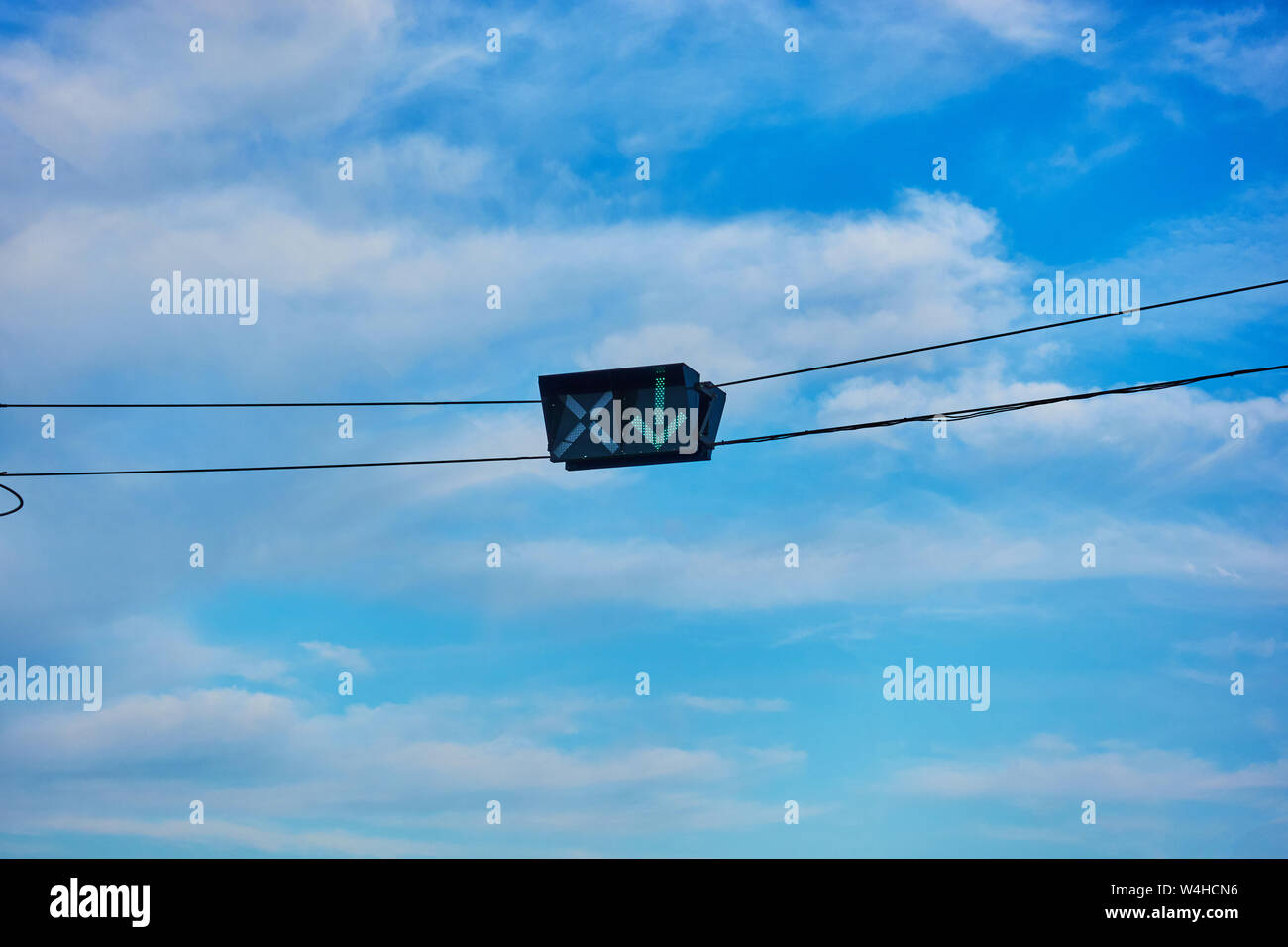 Road sign with wires against the sky indicating reversible traffic ...