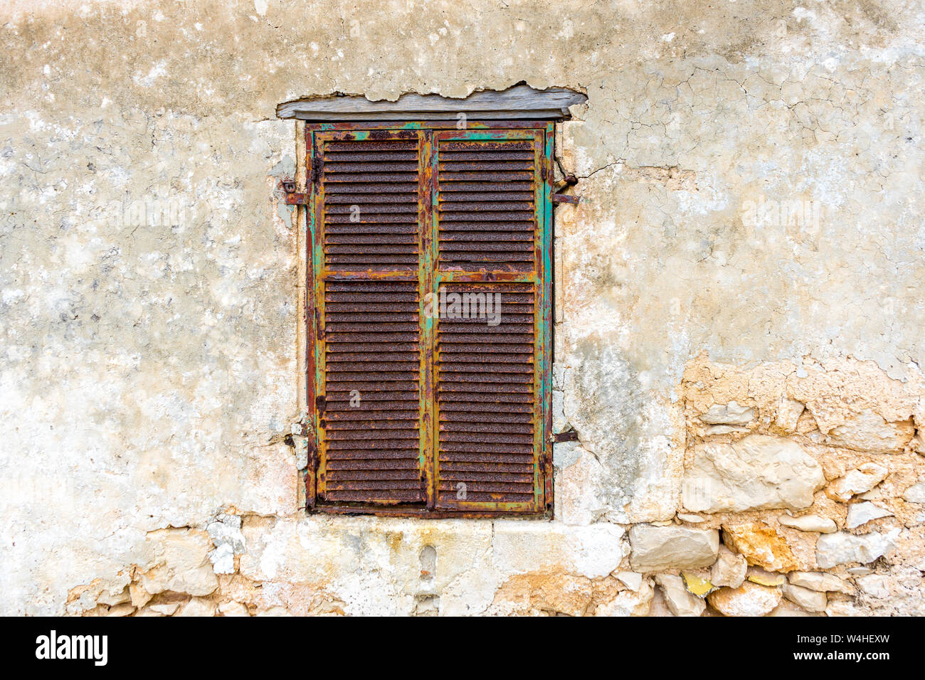 Rusty old rotten closed folding shutter on an ancient building Stock ...