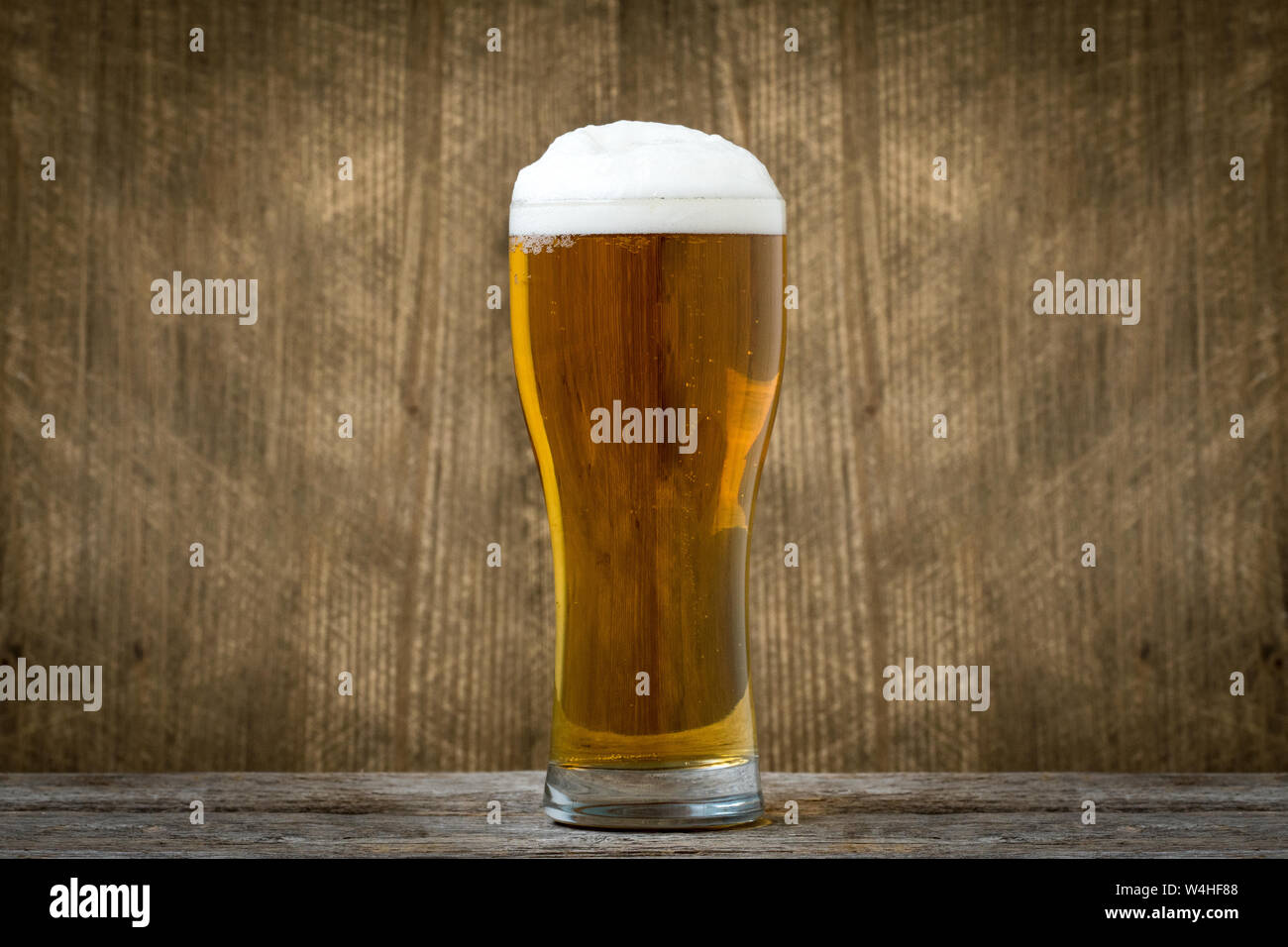 Glass of light lager beer on dark wooden background background Stock ...