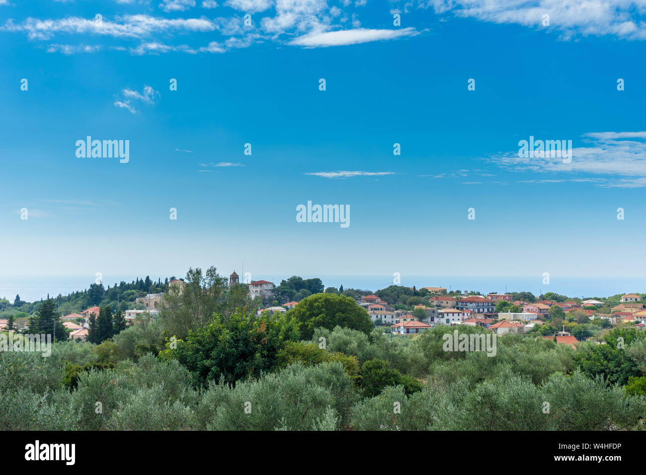 Greece, Zakynthos, Houses of keri village on green hills and ocean in ...