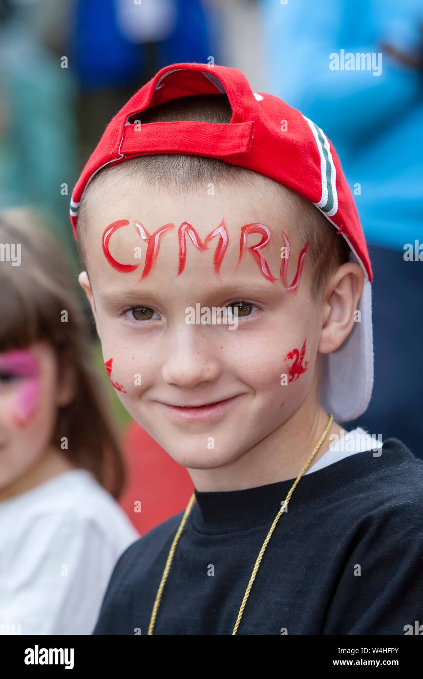 Portrait of a young Welsh boy with baseball cap on backwards and face ...