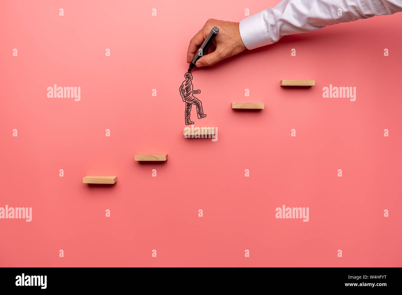 Male hand drawing a silhouette of a man walking up the wooden steps in ...