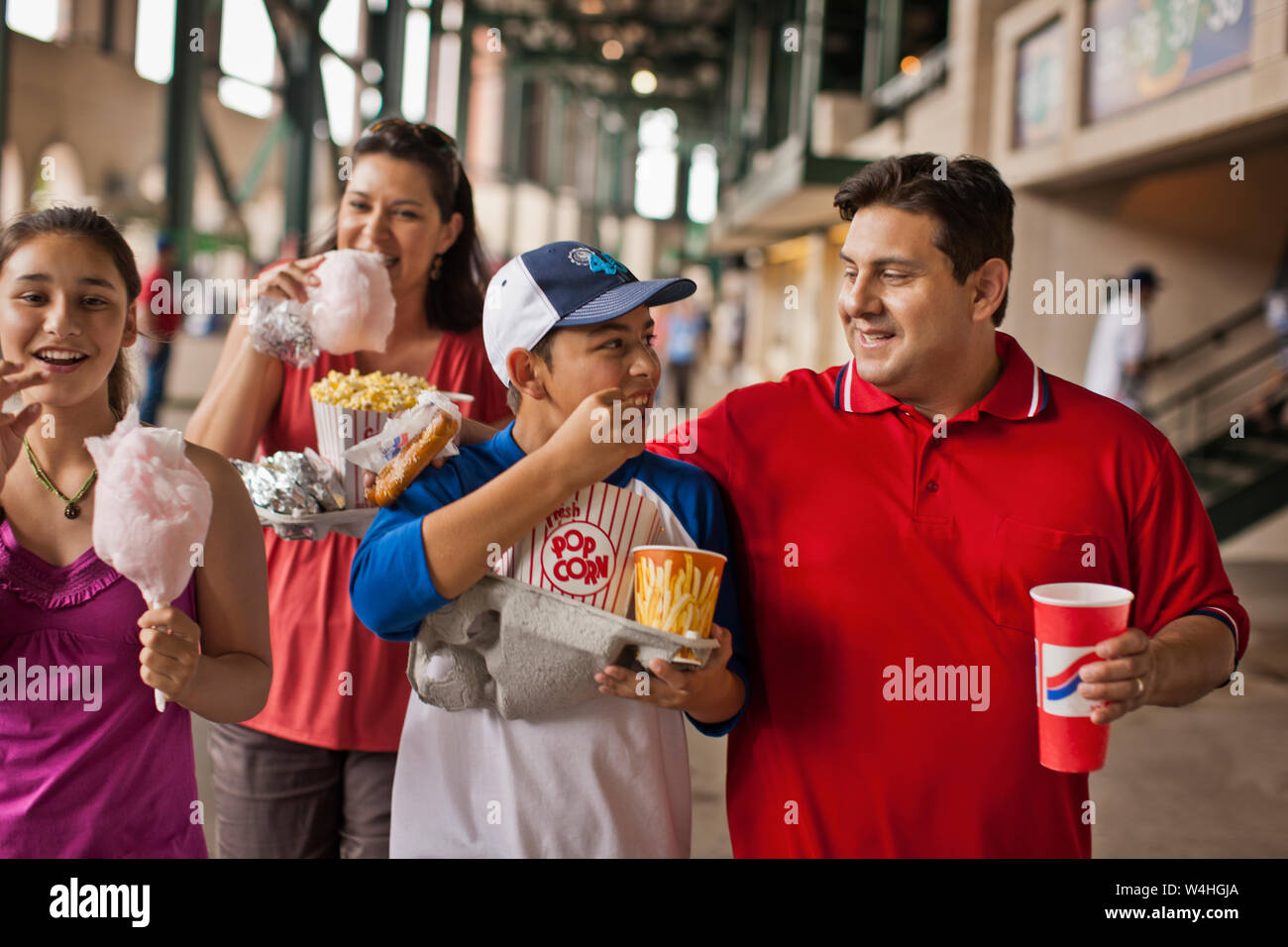 Happy family enjoying a day out at a sporting event Stock Photo - Alamy