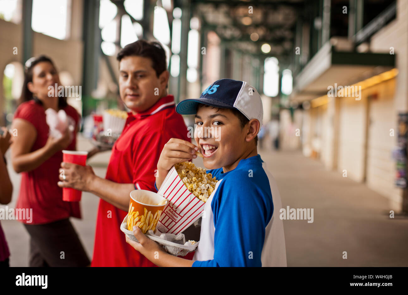 Happy family enjoying a day out at a sporting event Stock Photo - Alamy