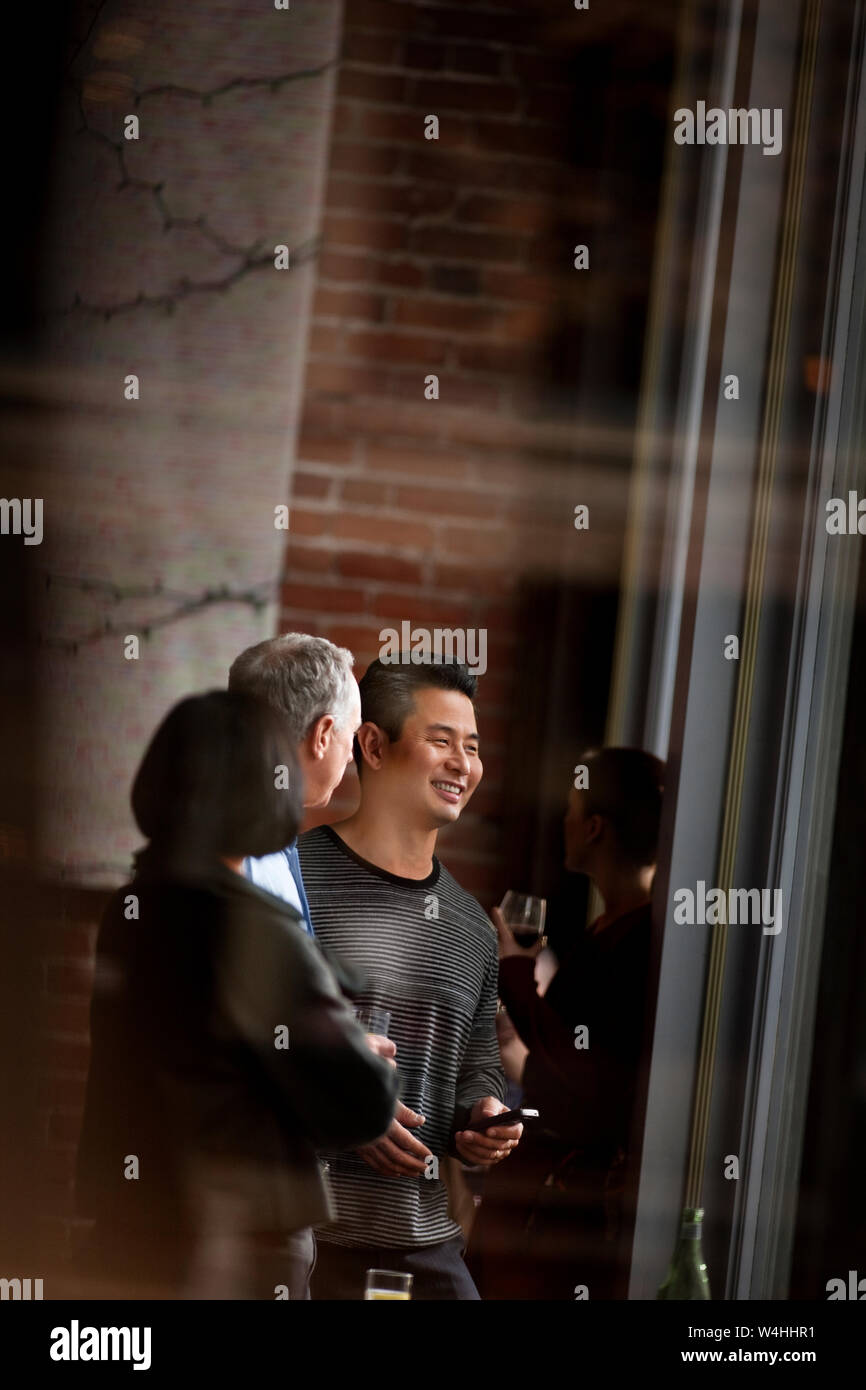 Colleagues enjoy having a drink and a casual chat after work Stock ...