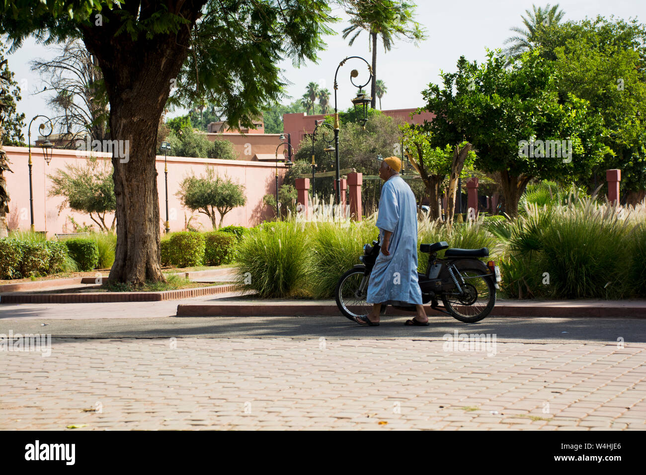Local moroccan people walk around Marrakech Katoubia garden and park ...