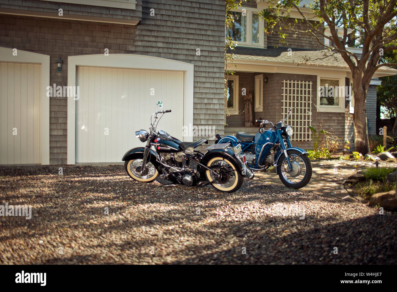 Two motorcycles parked on a gravel driveway Stock Photo - Alamy