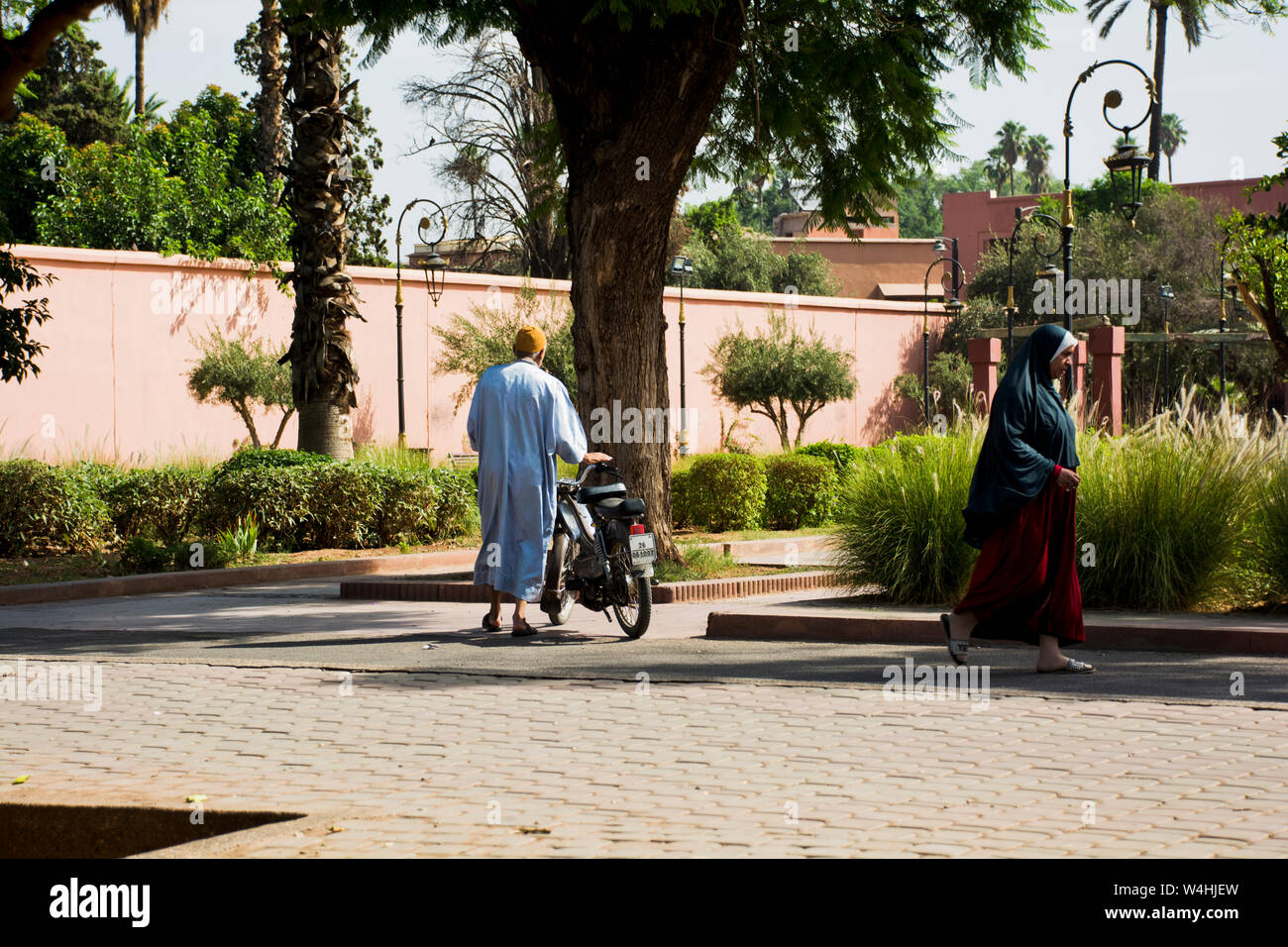 Local moroccan people walk around Marrakech Katoubia garden and park ...