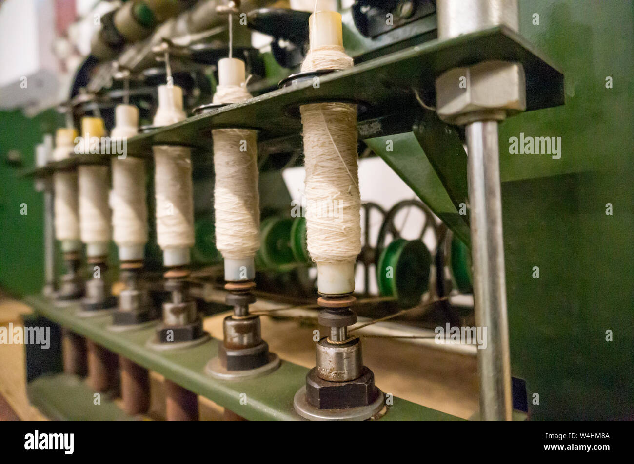 Green spindle weaving machine used to make cloth Stock Photo - Alamy