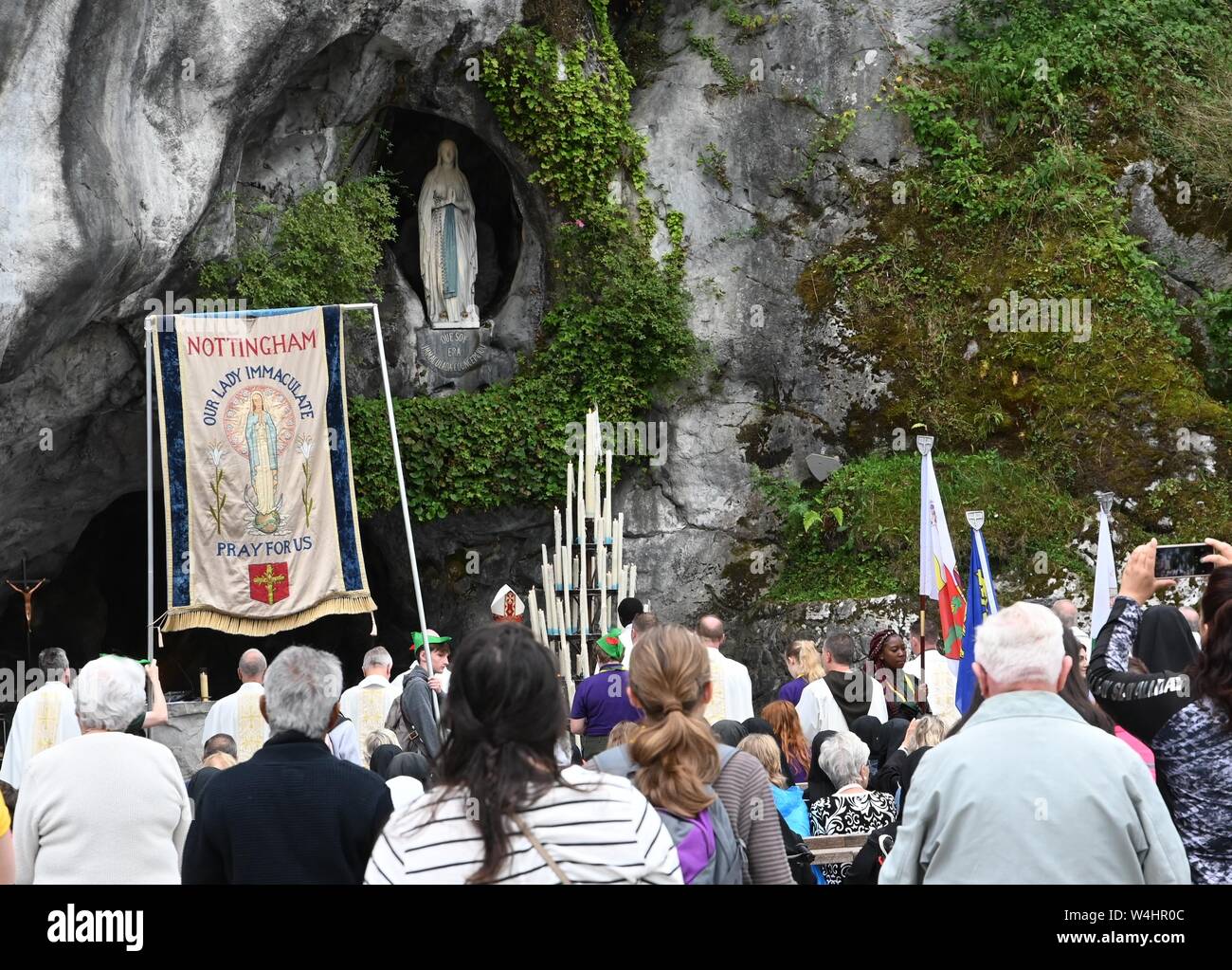 Pilgrims attend Mass at the grotto in Lourdes, France Stock Photo - Alamy