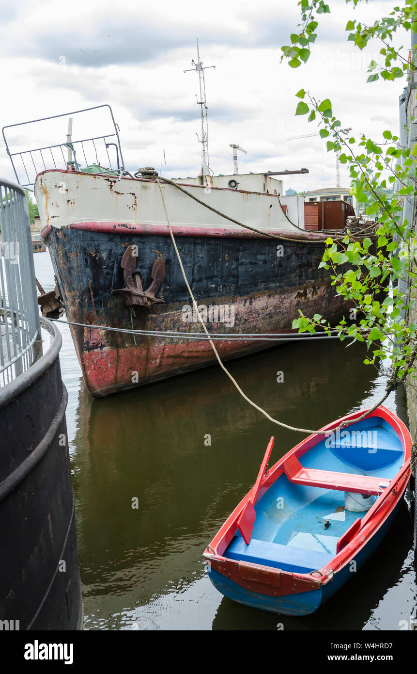 Old shipwreck in harbor with new rowboat in foreground Stock Photo - Alamy