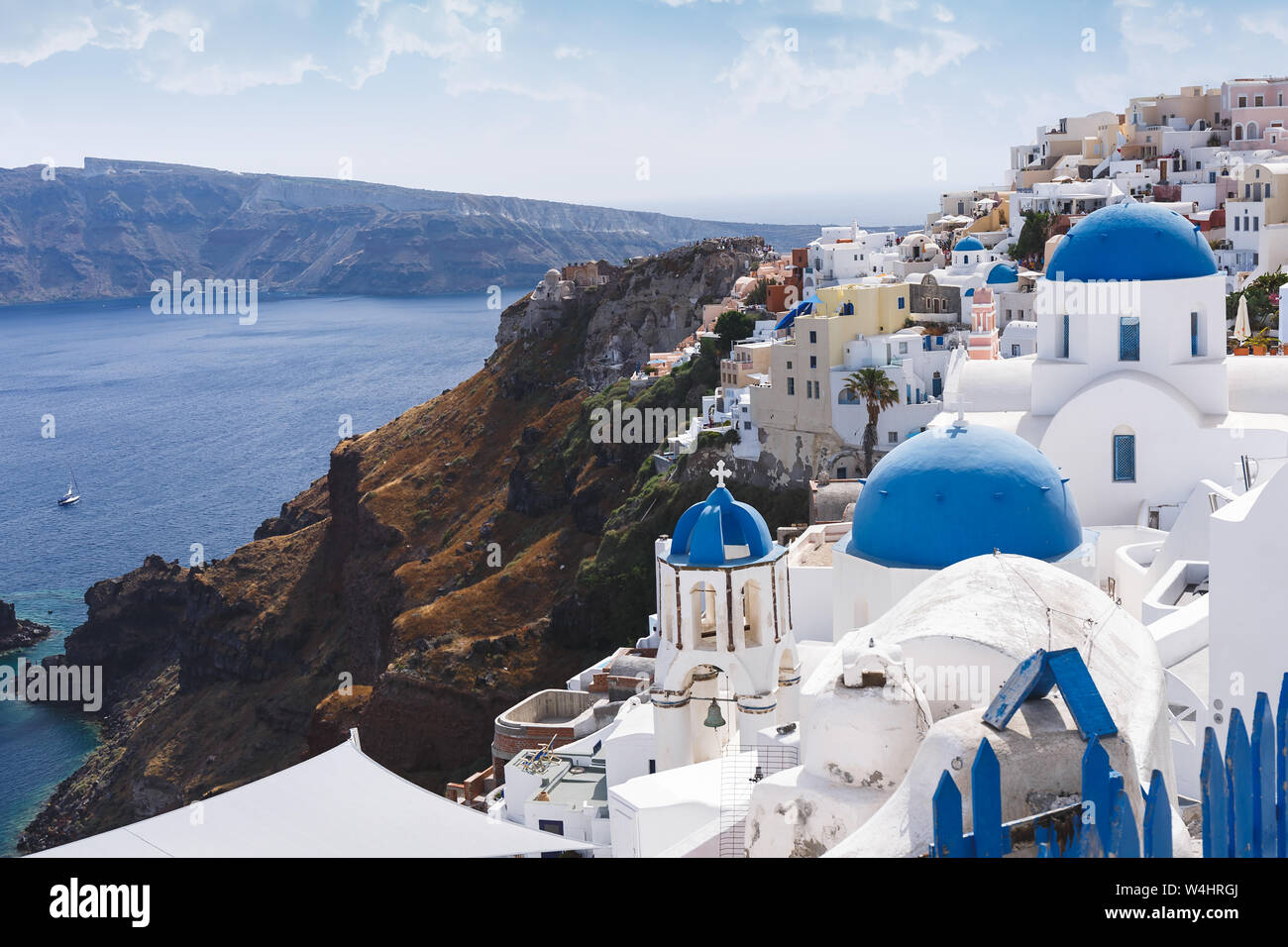 Blue domes and bell tower of churches in Oia, Santorini, Greece. The ...