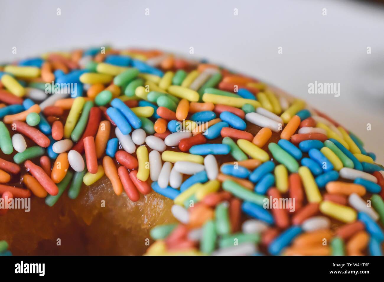 Rainbow sprinkles on doughnut hi-res stock photography and images - Alamy
