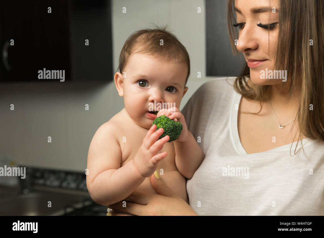 Adorable baby eating broccoli hi-res stock photography and images - Alamy