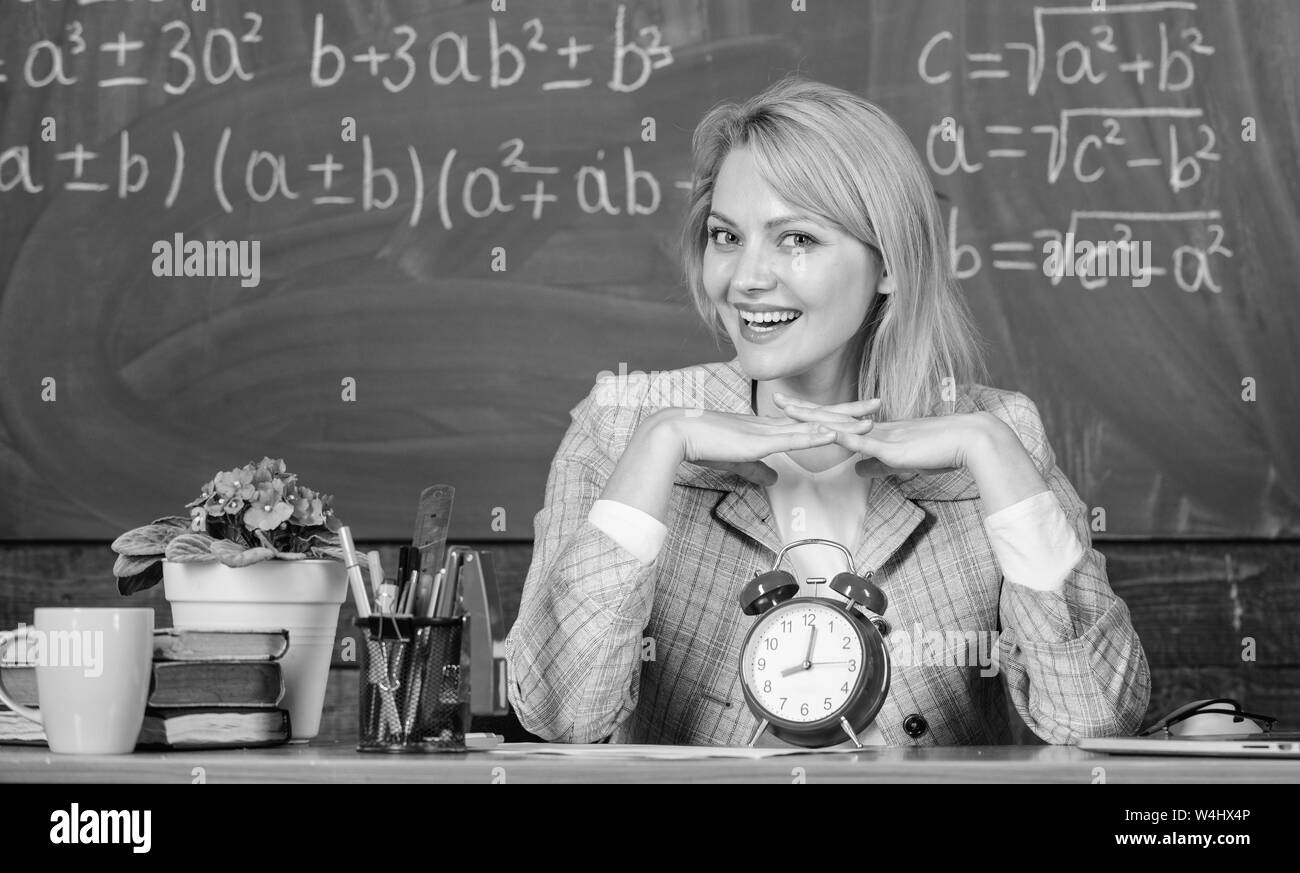teacher with alarm clock at blackboard. Time. Study and education ...