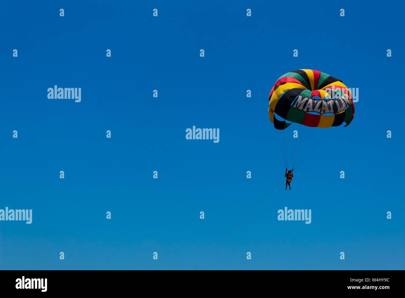 Hispanic tourist enjoying a parachute ride on Mazatlan Beach Stock ...