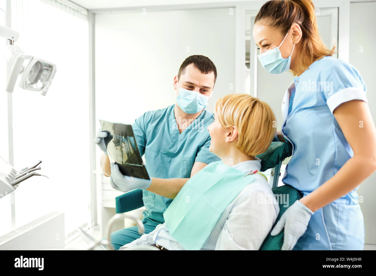 Female dentist showing x ray to patient at medical clinic hi-res stock ...
