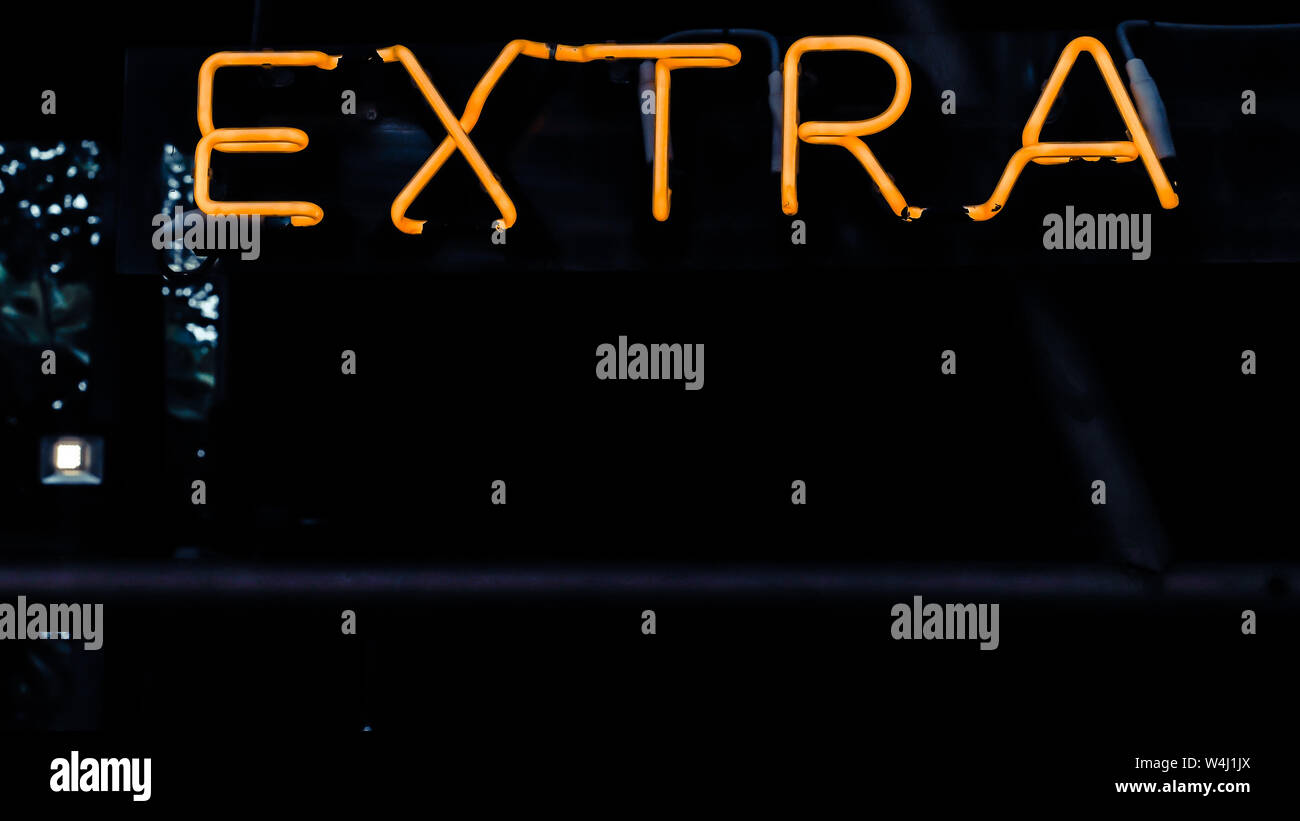 Extra word light signs .glowing neon bar alphabet on the dark ...