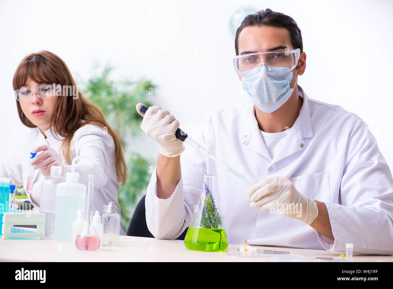 Two chemists working in the lab Stock Photo - Alamy
