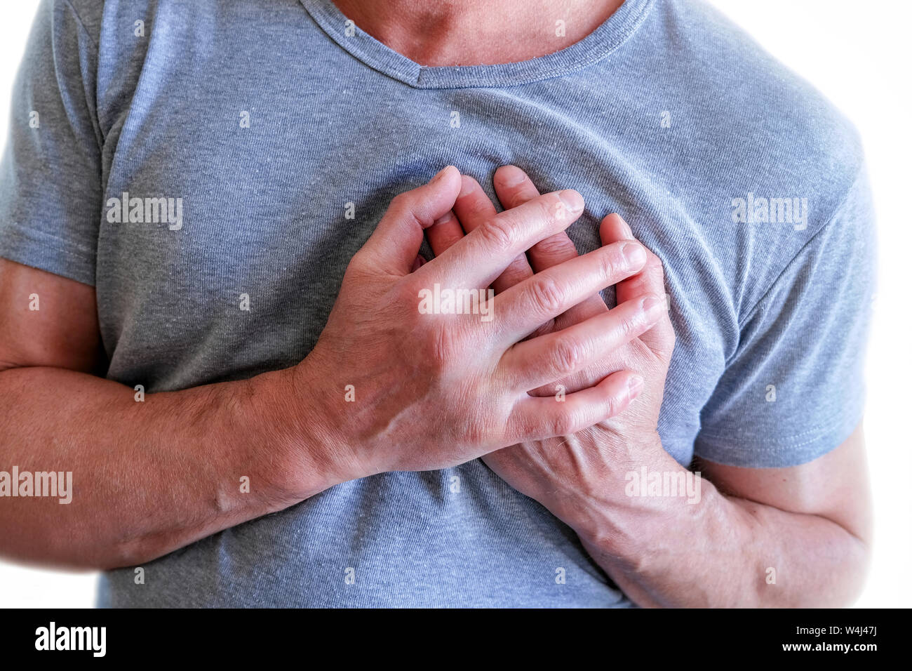 The man put his hands around the chest, pain in . Chest spasm, angina ...