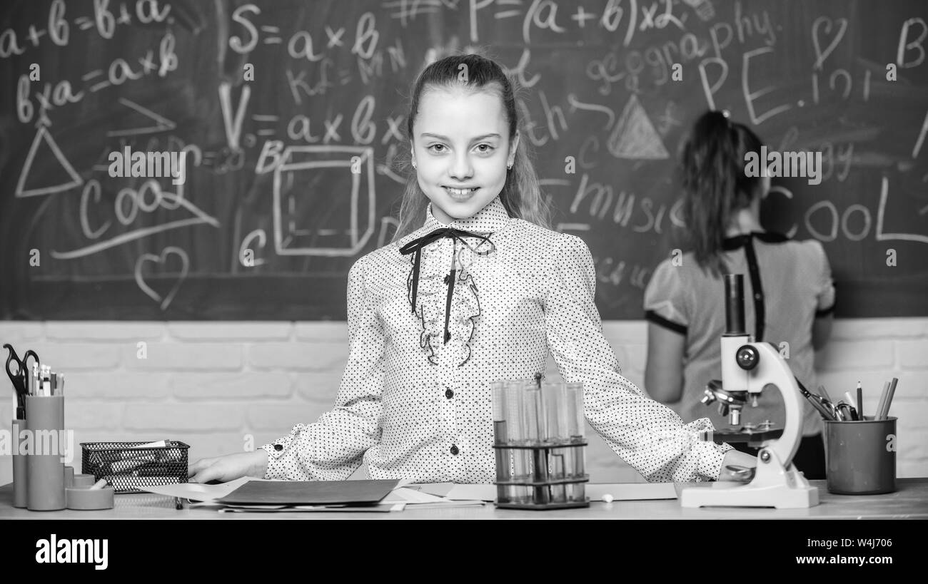 Girls study chemistry in school. Microscope test tubes chemical ...