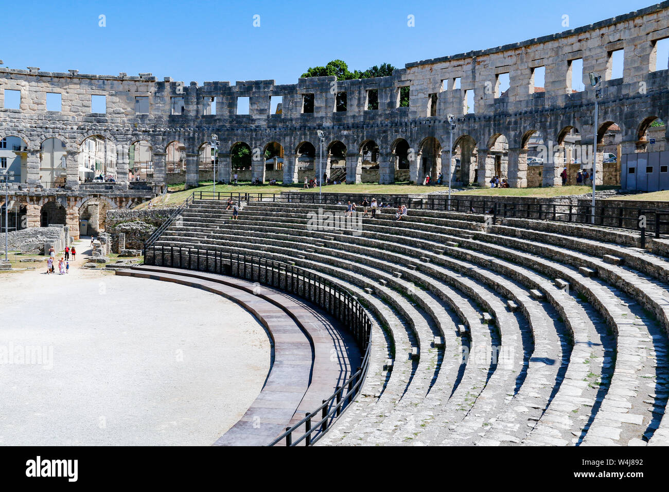 Tourists explore inside Pula Arena, a Roman amphitheatre built in ...