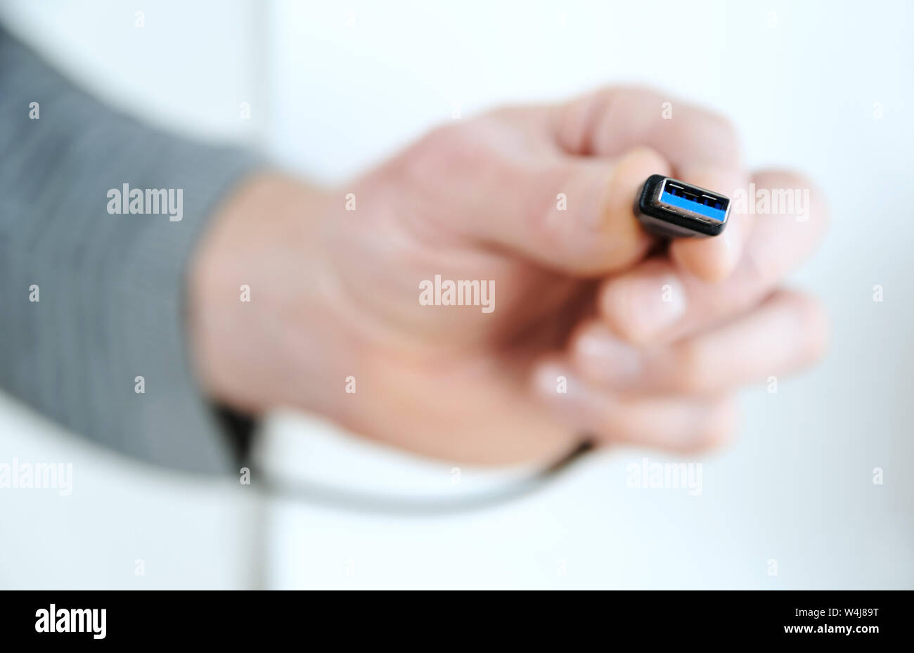 The hand of man is holding the cable plug usb3 Stock Photo - Alamy