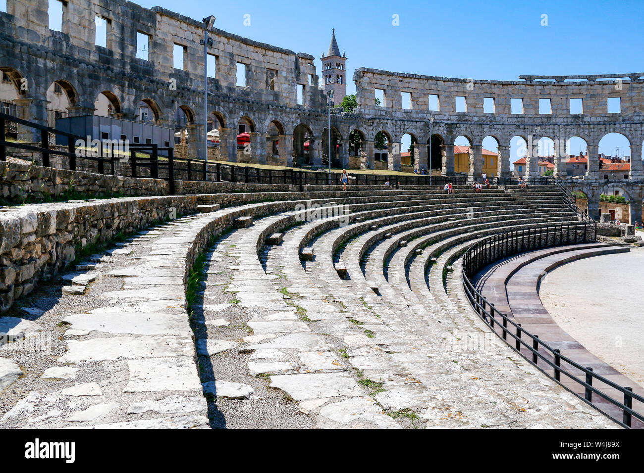 Tourists explore inside Pula Arena, a Roman amphitheatre built in ...