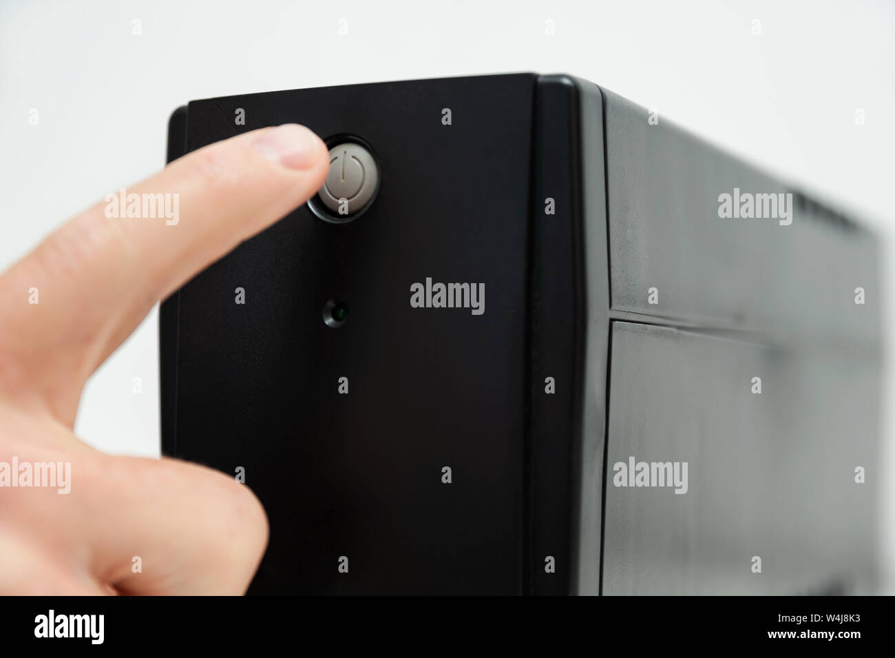 The index finger is pressing the start button of the uninterrupted ...