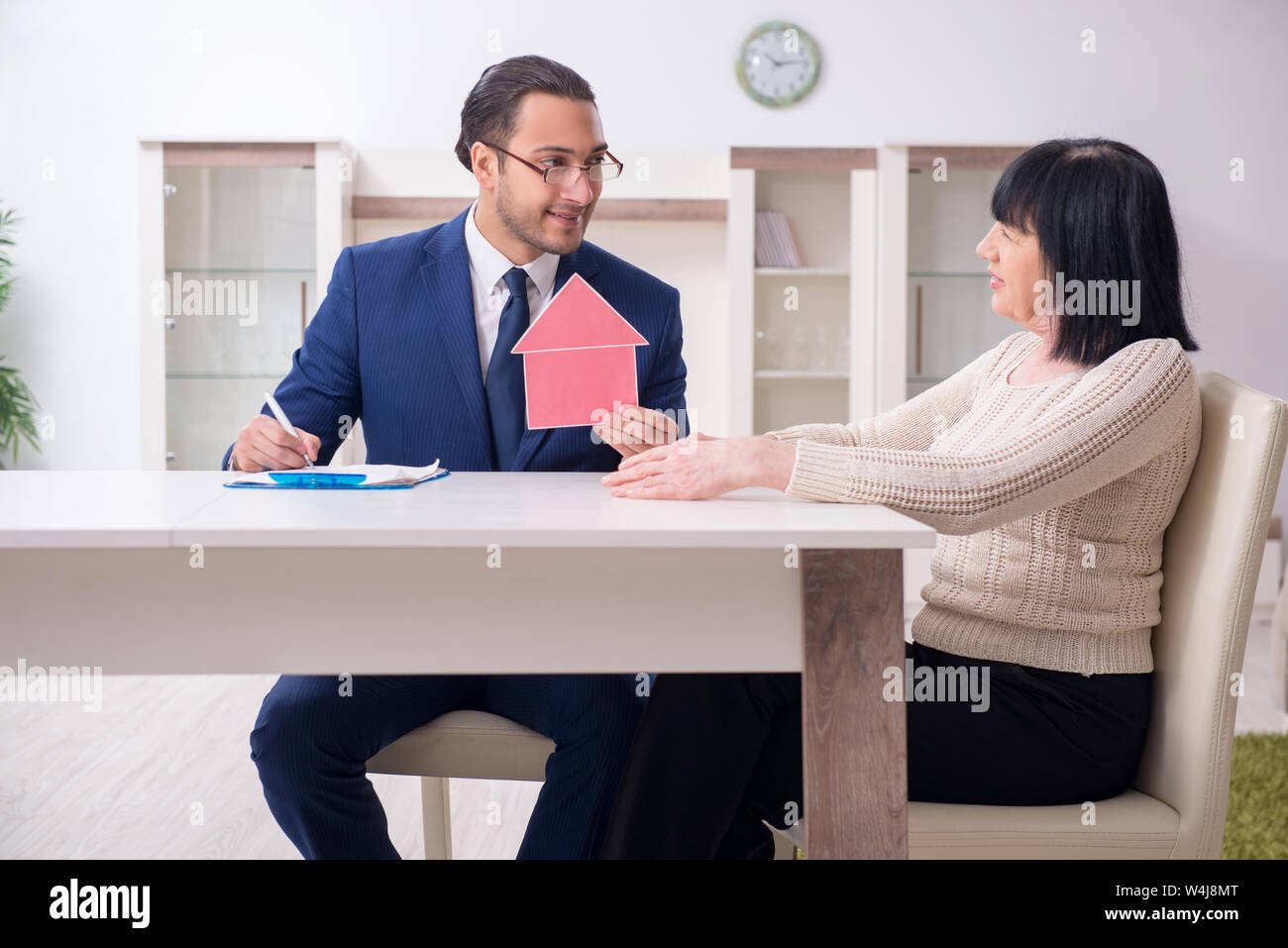 Male real estate agent and female client in the apartment Stock Photo ...
