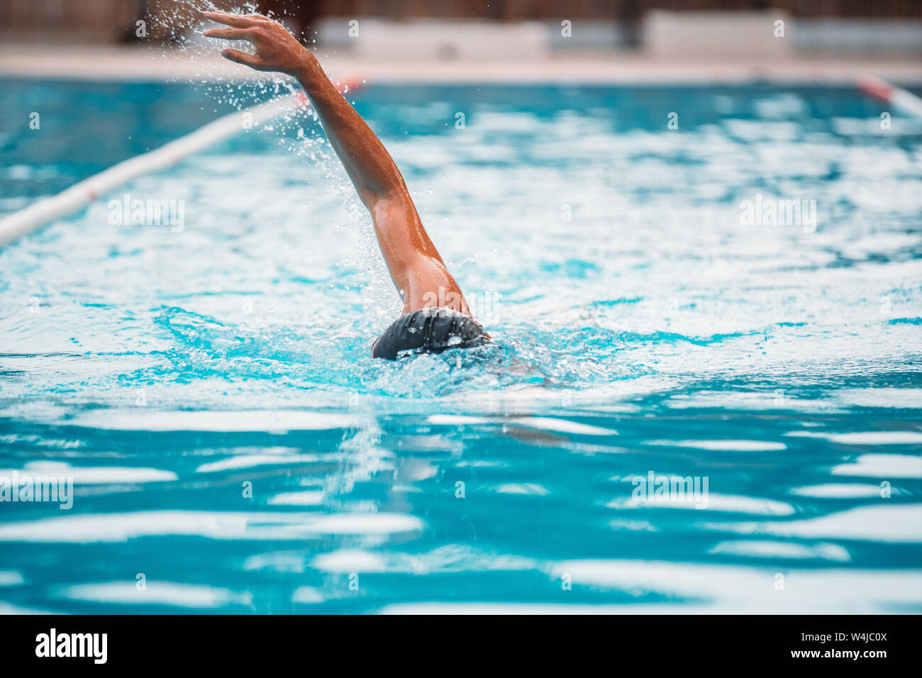 Athletic Young man swimming the front crawl in a pool. Swimming ...