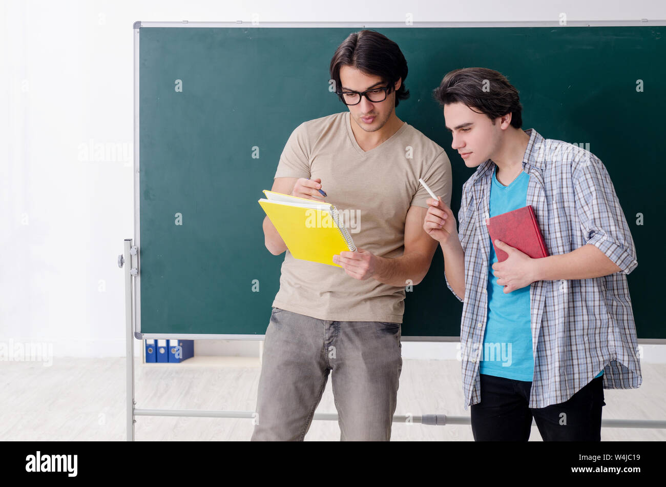 Two male students in the classroom Stock Photo - Alamy