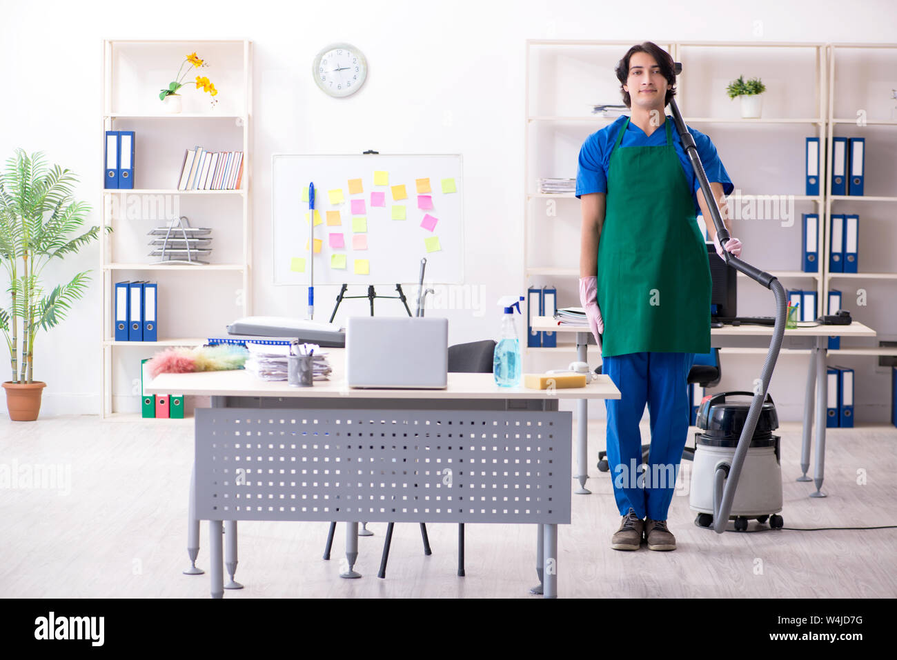 Male handsome professional cleaner working in the office Stock Photo ...